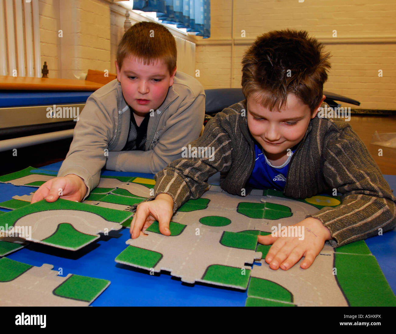 Two 10 year old school pupils at Feltham Hill Junior School engaging in ...