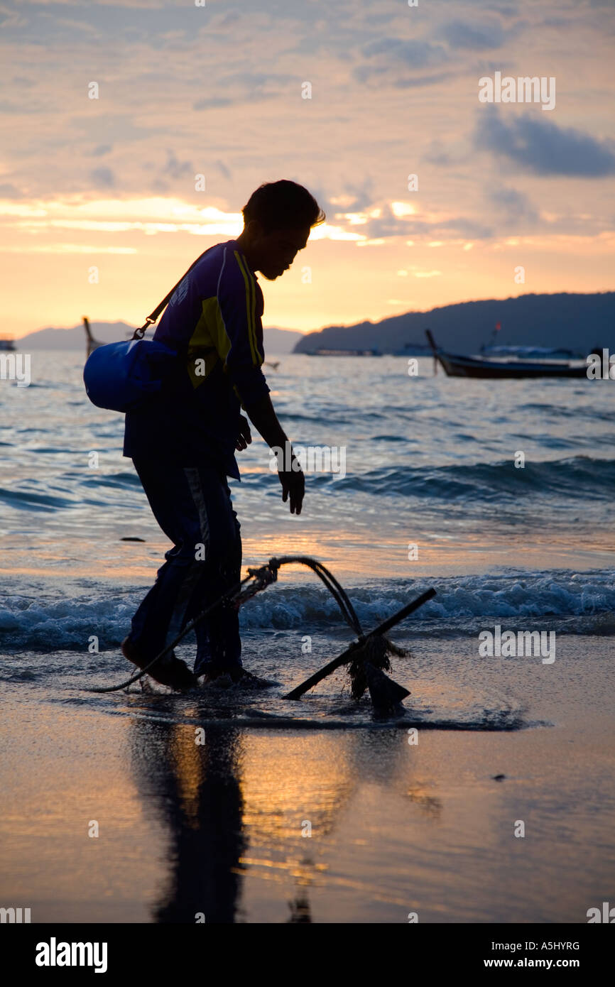 Boatman Lifting the anchor of longtailed boat Railey Beach lagoon ...
