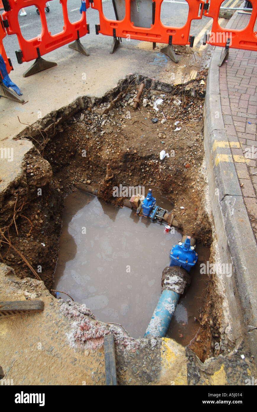 Hole in the road for replacement of ageing cast iron water main and ...