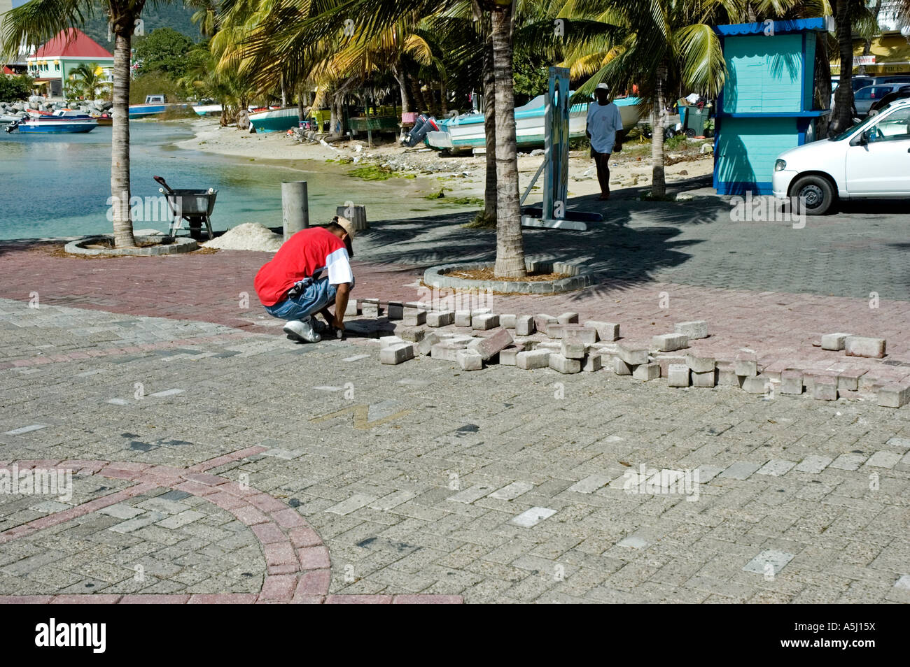 Paviour laying paving blocks, St Maarten Stock Photo - Alamy