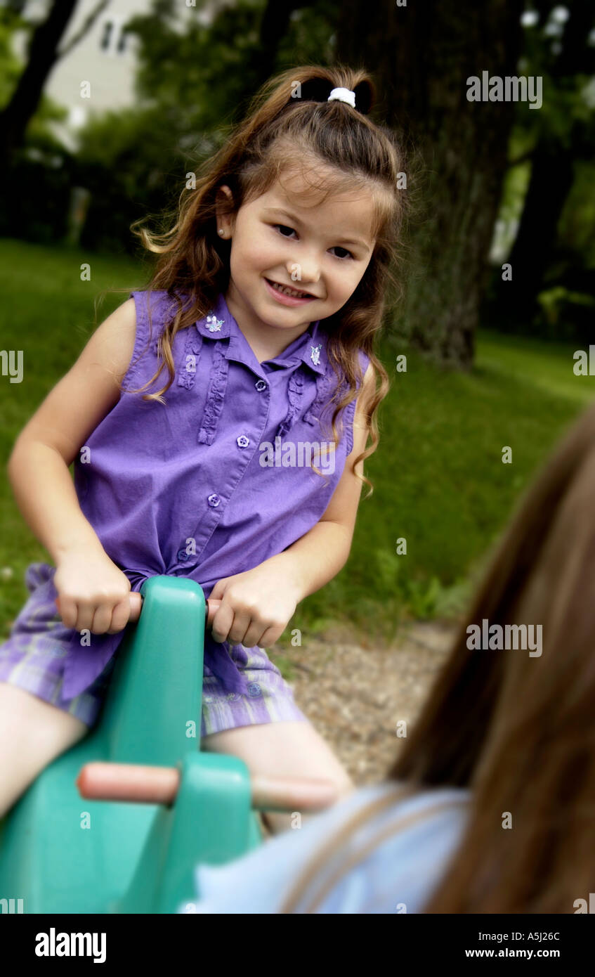 Girl on teeter totter hi-res stock photography and images - Alamy