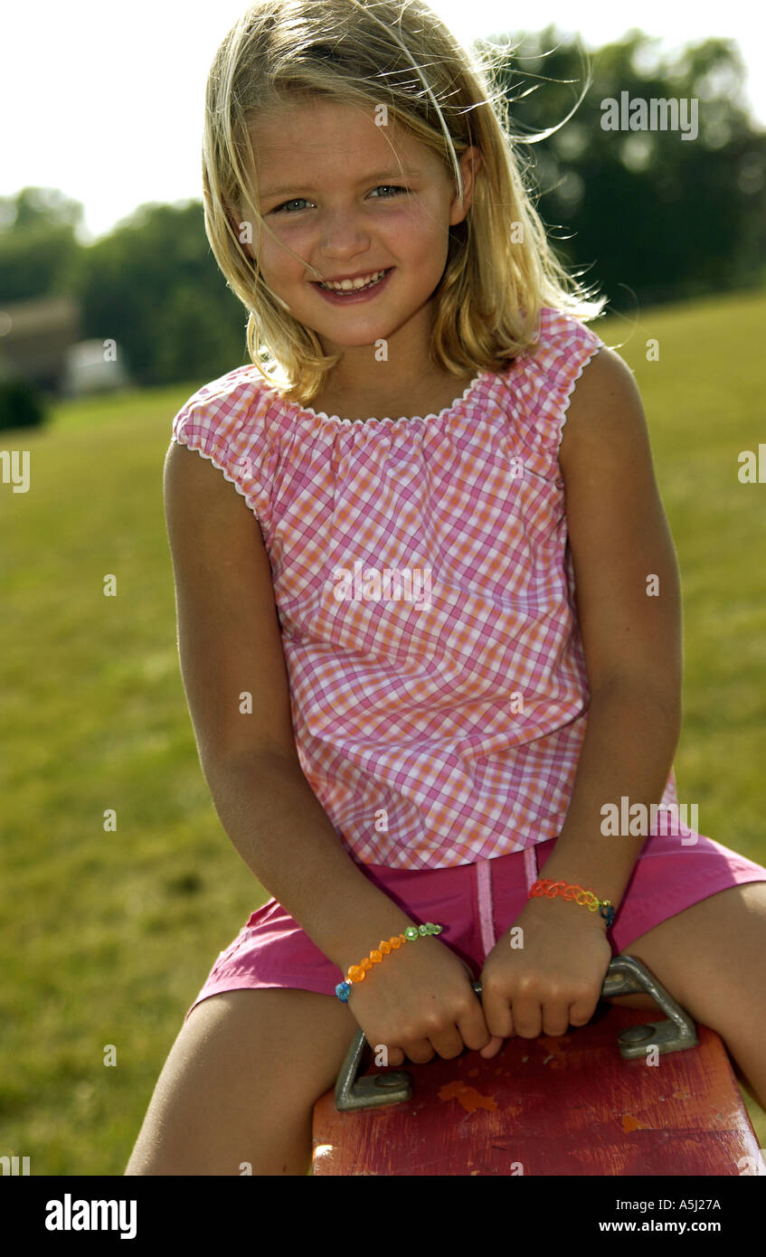 Girl on teeter totter Stock Photo - Alamy