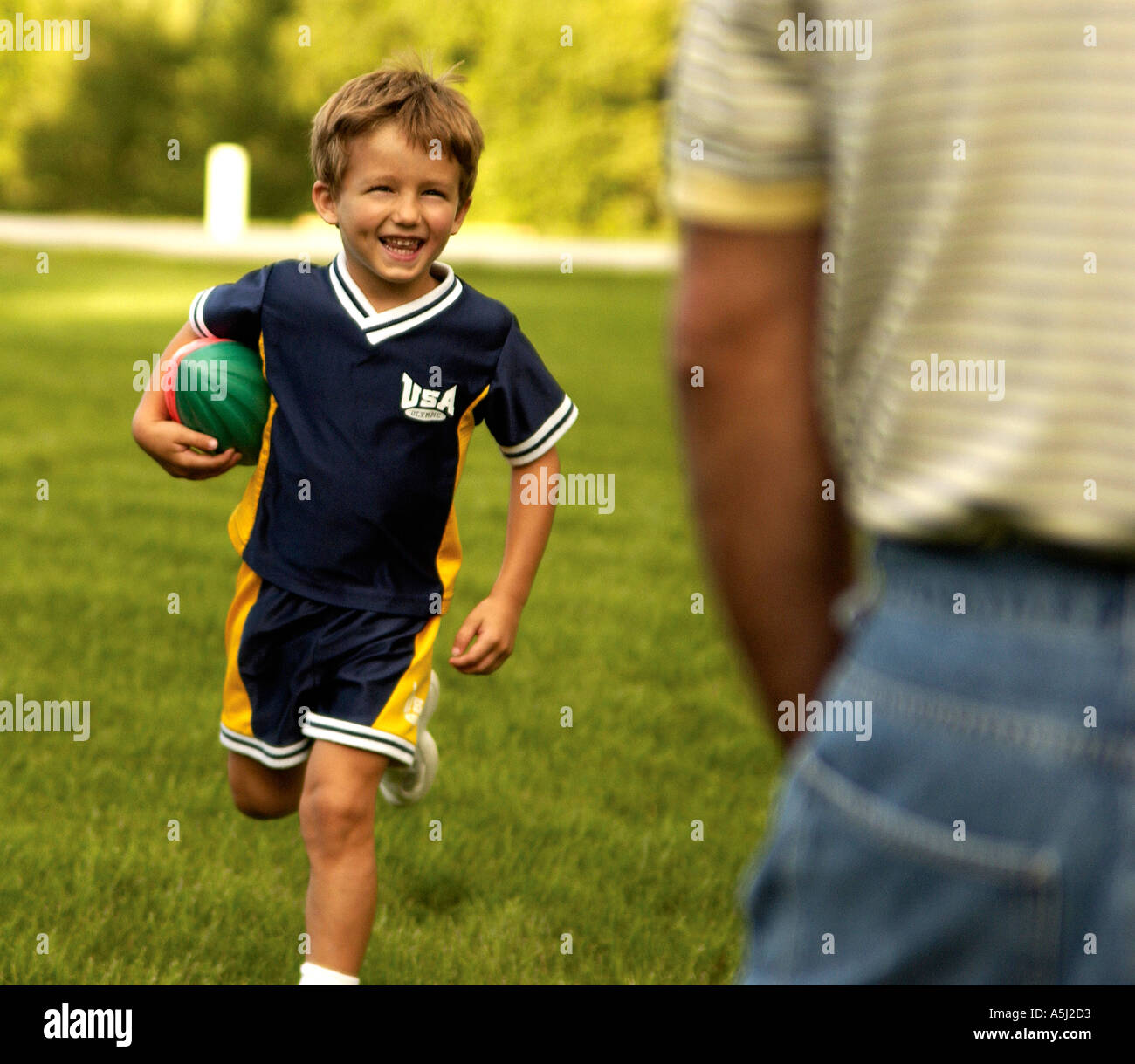 Boy playing football Stock Photo - Alamy