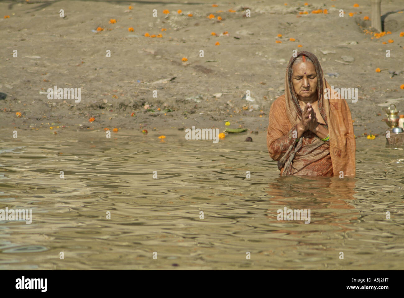 Woman praying in the Ganges River in Varanasi, India Stock Photo - Alamy