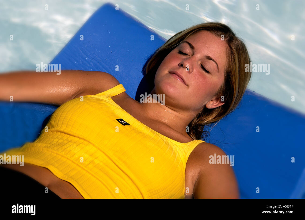 Sunglasses and two glasses of water by swimming pool hi-res stock ...