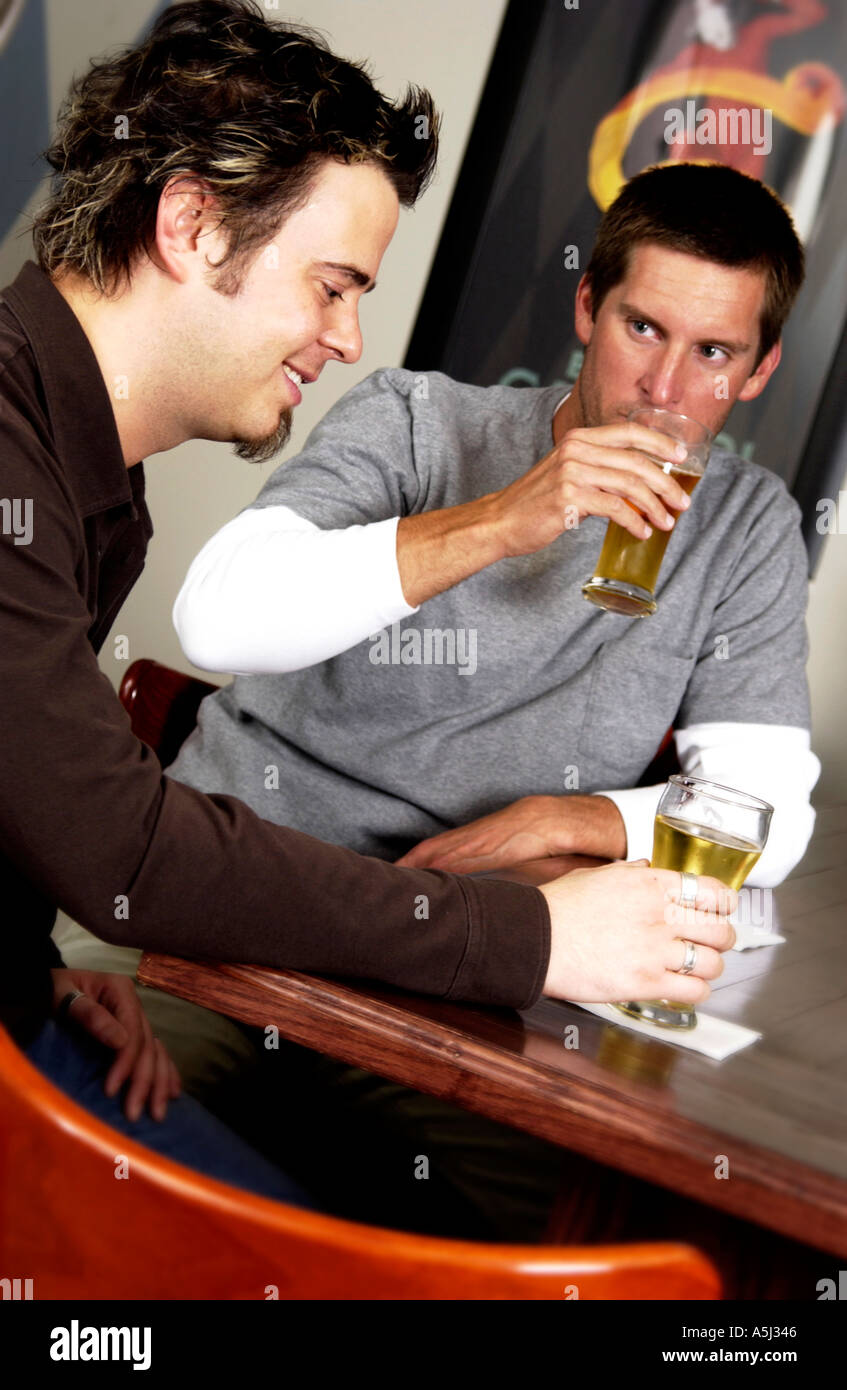 Two men drinking at a bar Stock Photo - Alamy