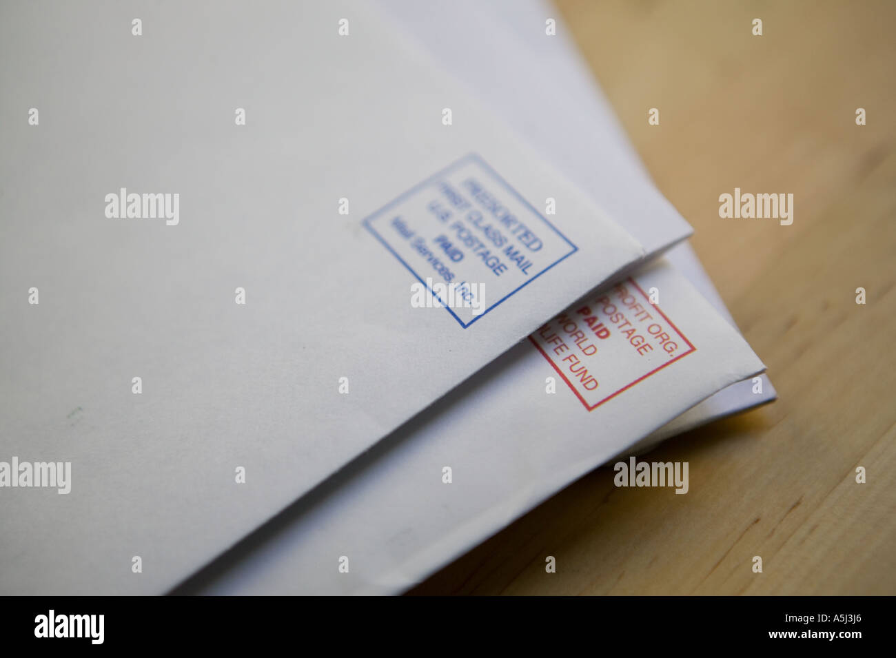 A pile of mail rests on a wooden table surface February 2006 Stock ...