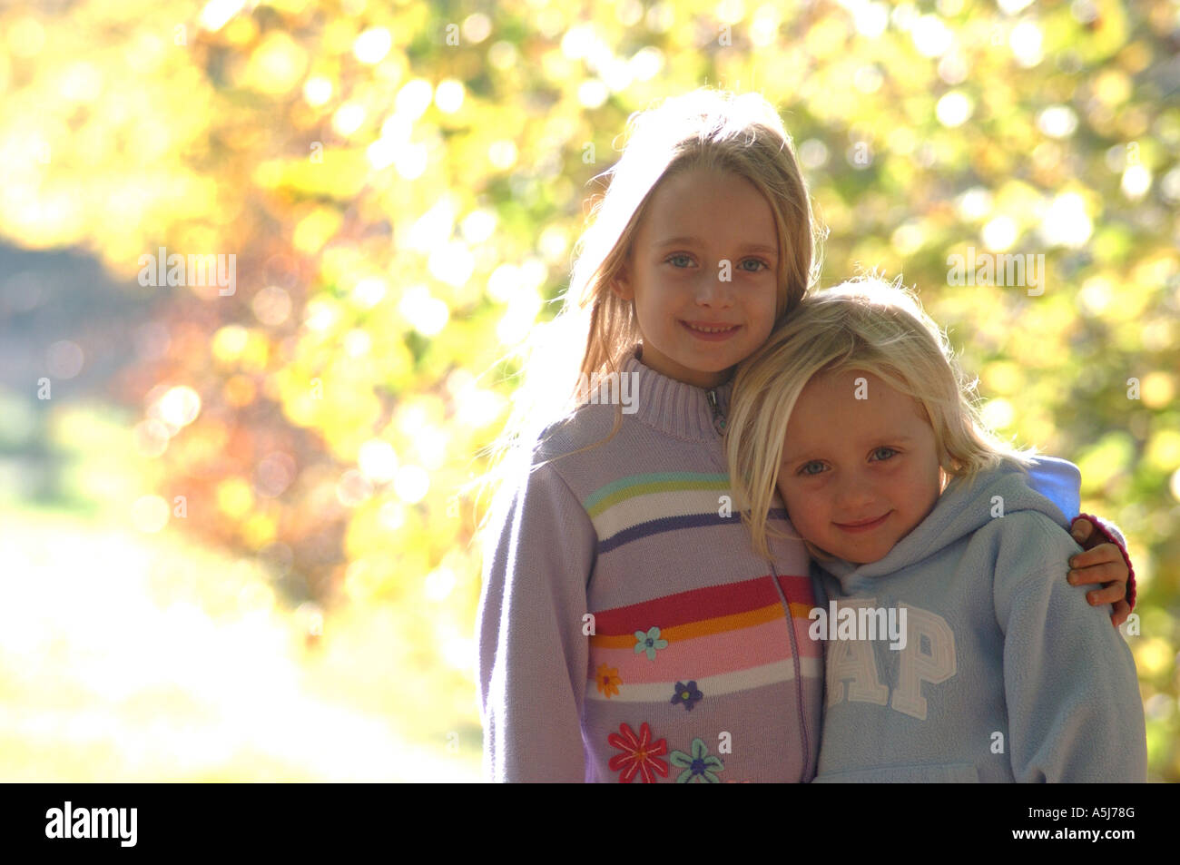British friends together smiling in sunlight in park in London UK Stock ...