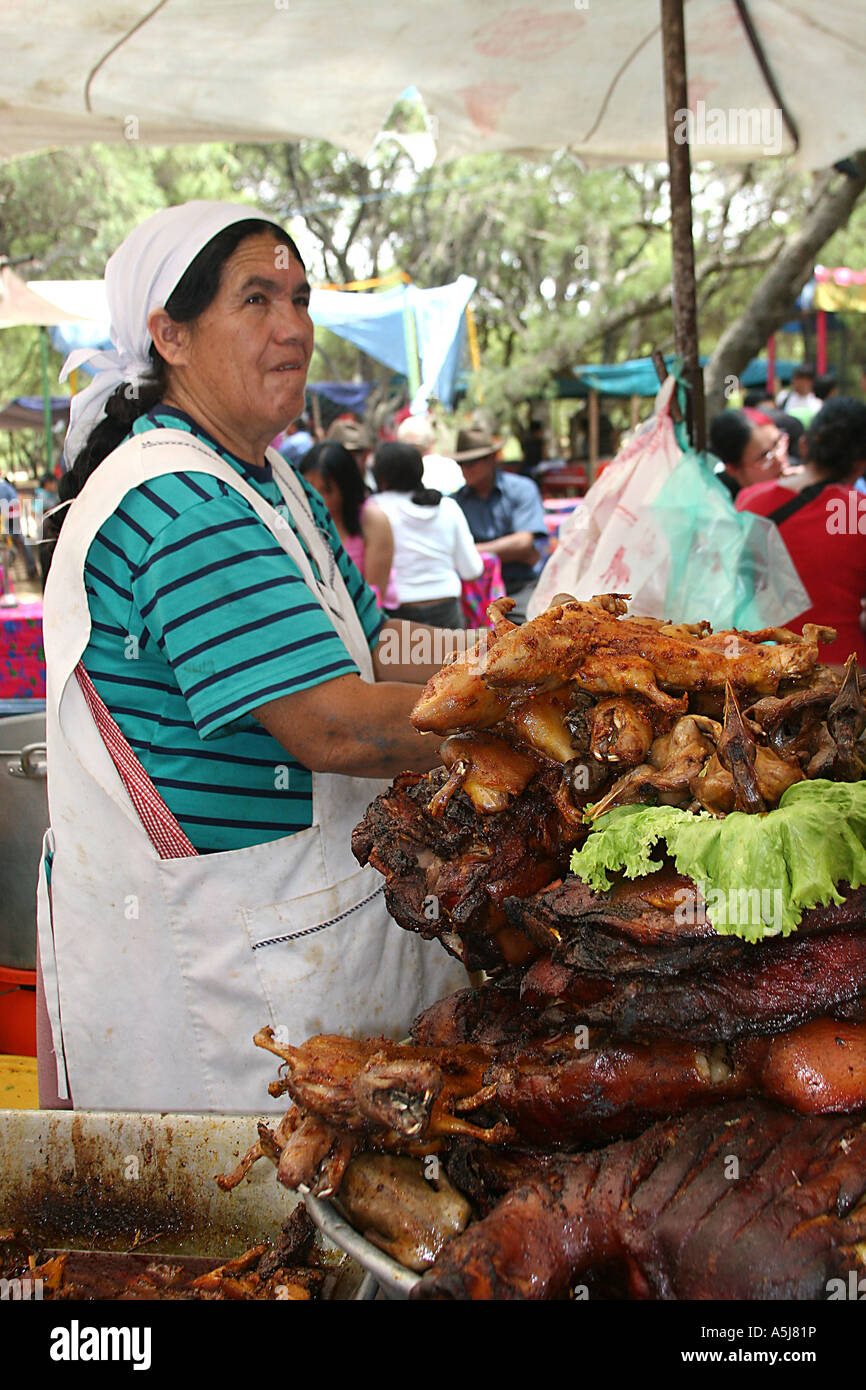 A traditional woman selling grilled guinea pigs & Pork Stock Photo - Alamy