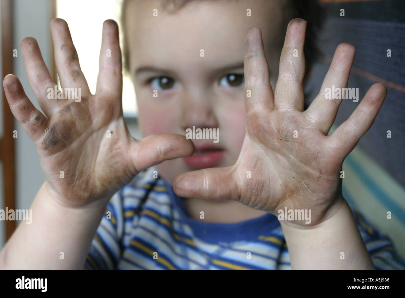 A dirty little boy shows us his grubby hands Stock Photo - Alamy