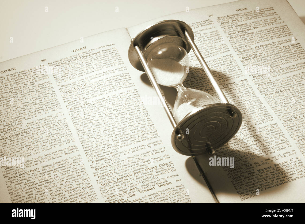 Hourglass on Book Stock Photo - Alamy