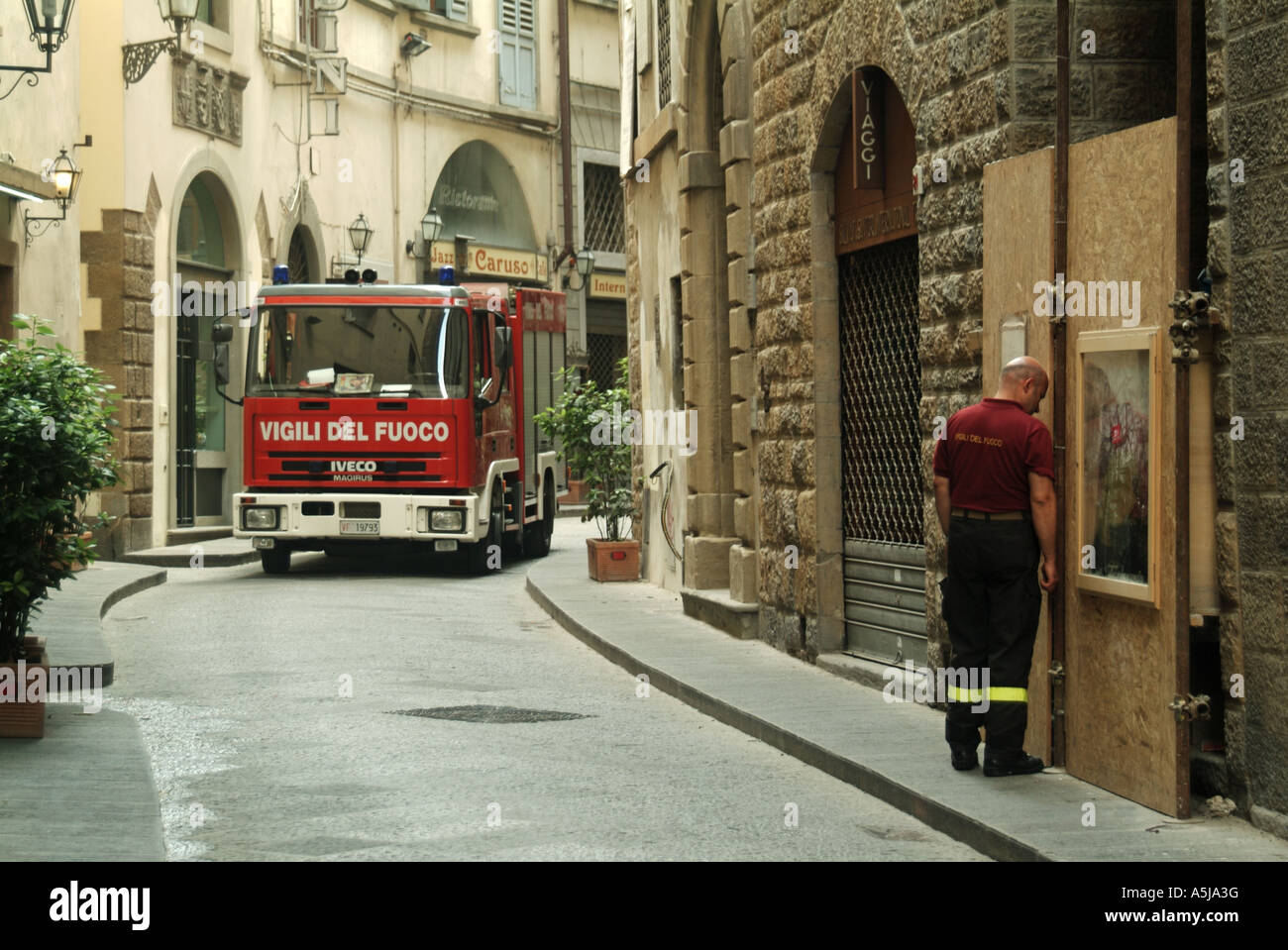 Florence fire engine in narrow side turning with fireman Stock Photo ...