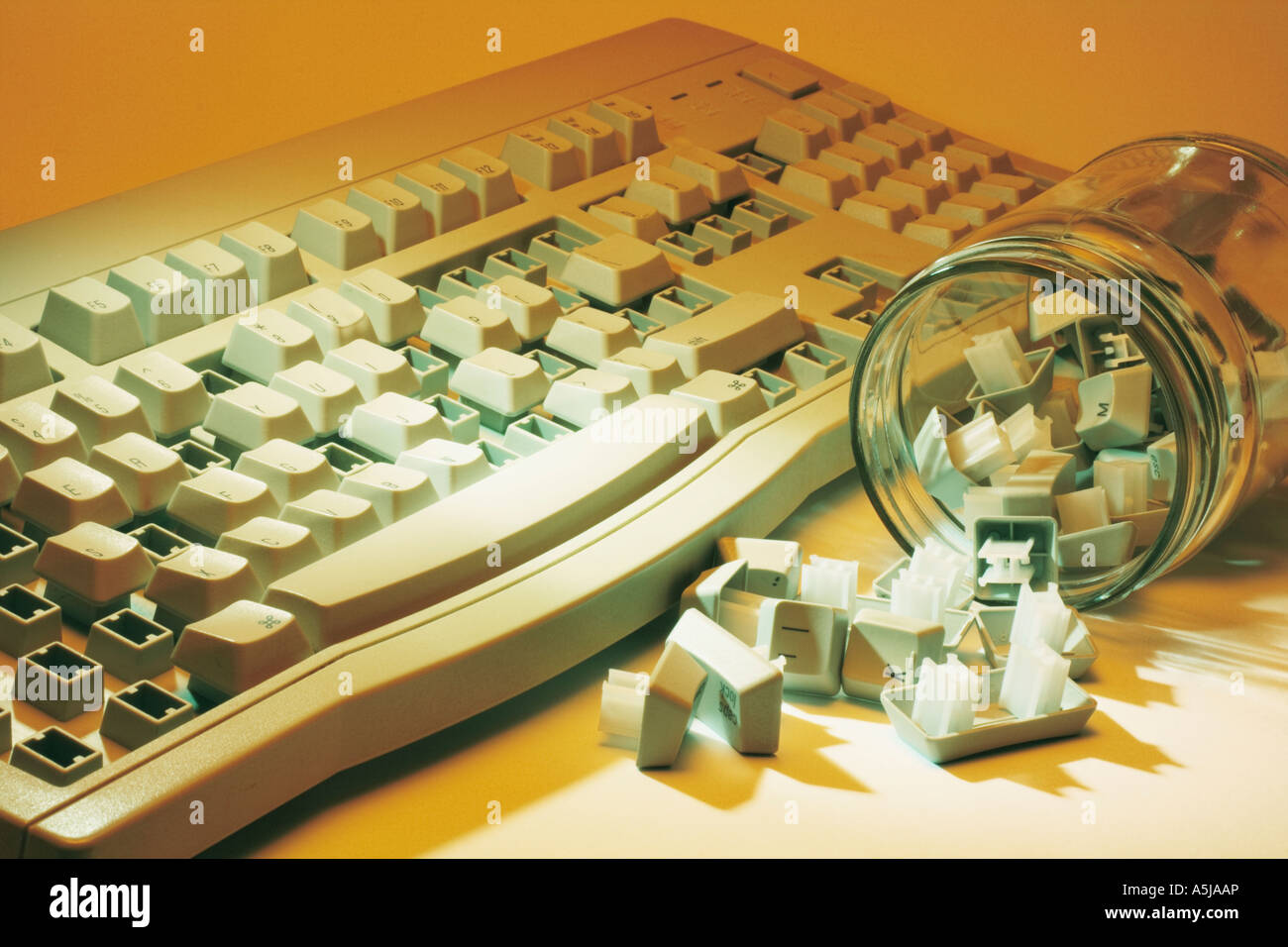 Damaged Computer Keyboard and Broken Keys in Glass Jar Stock Photo - Alamy