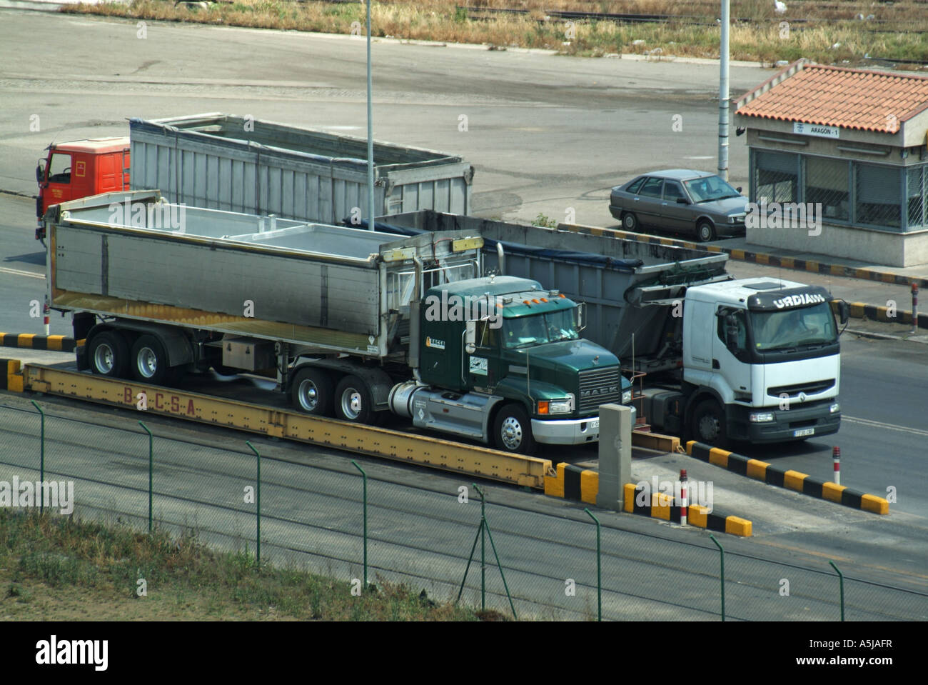 Looking down at Spanish lorry trucks with empty bulk carrier trailers ...
