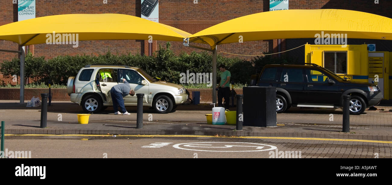 Large sun brolly style collapsible canopies over car washing area ...