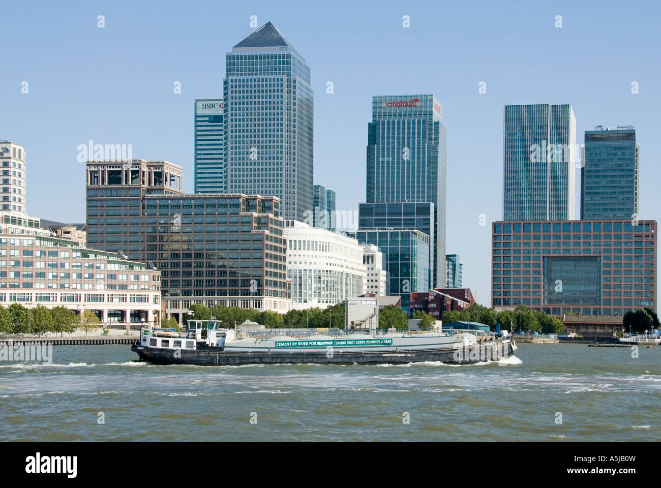 River Thames barge boat banner promotes moving bulk cement for Readymix ...