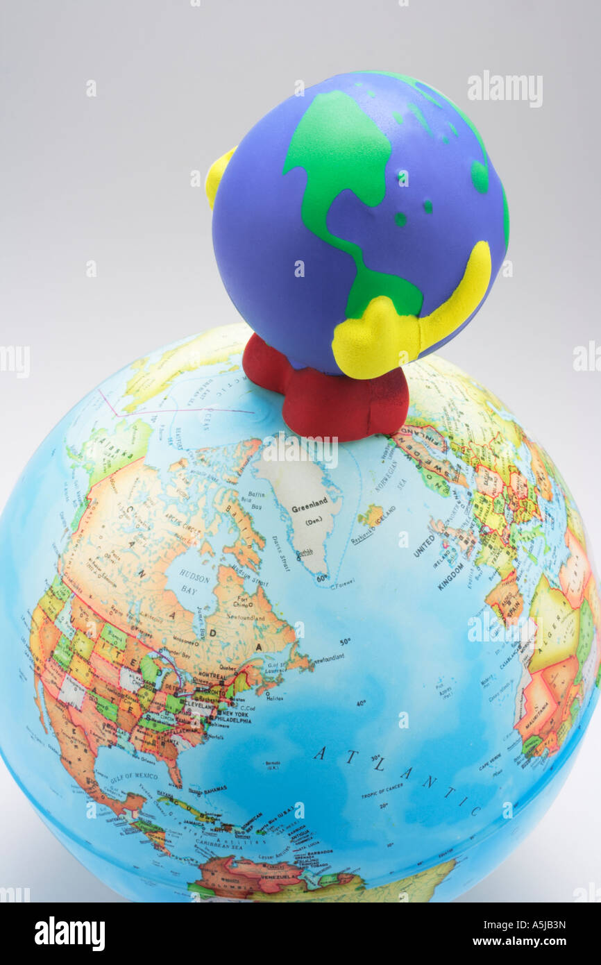 Toy Globe Figure Standing on Globe Stock Photo - Alamy