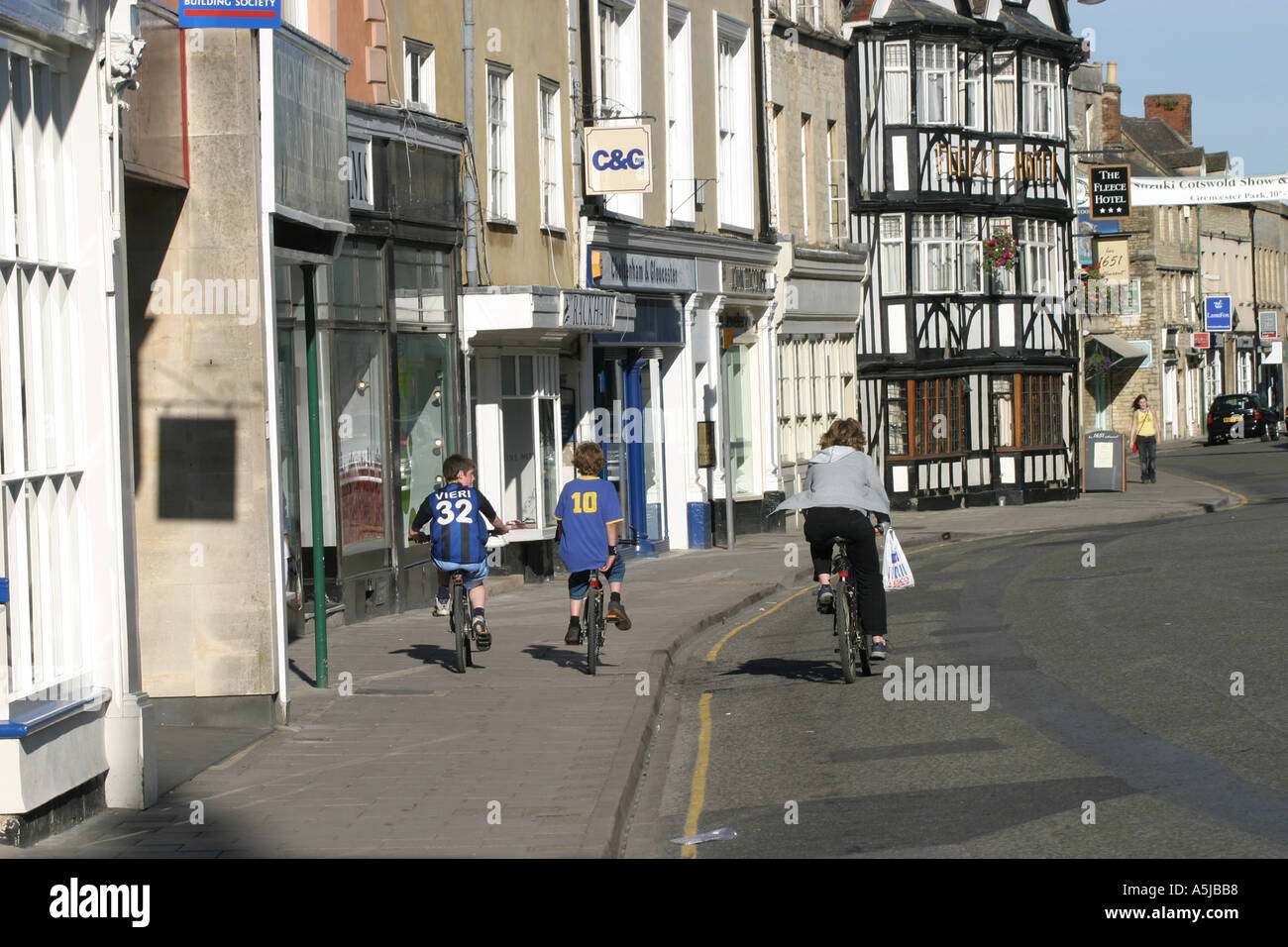 Cirencester High Street showing cyclists riding on the road and two on ...