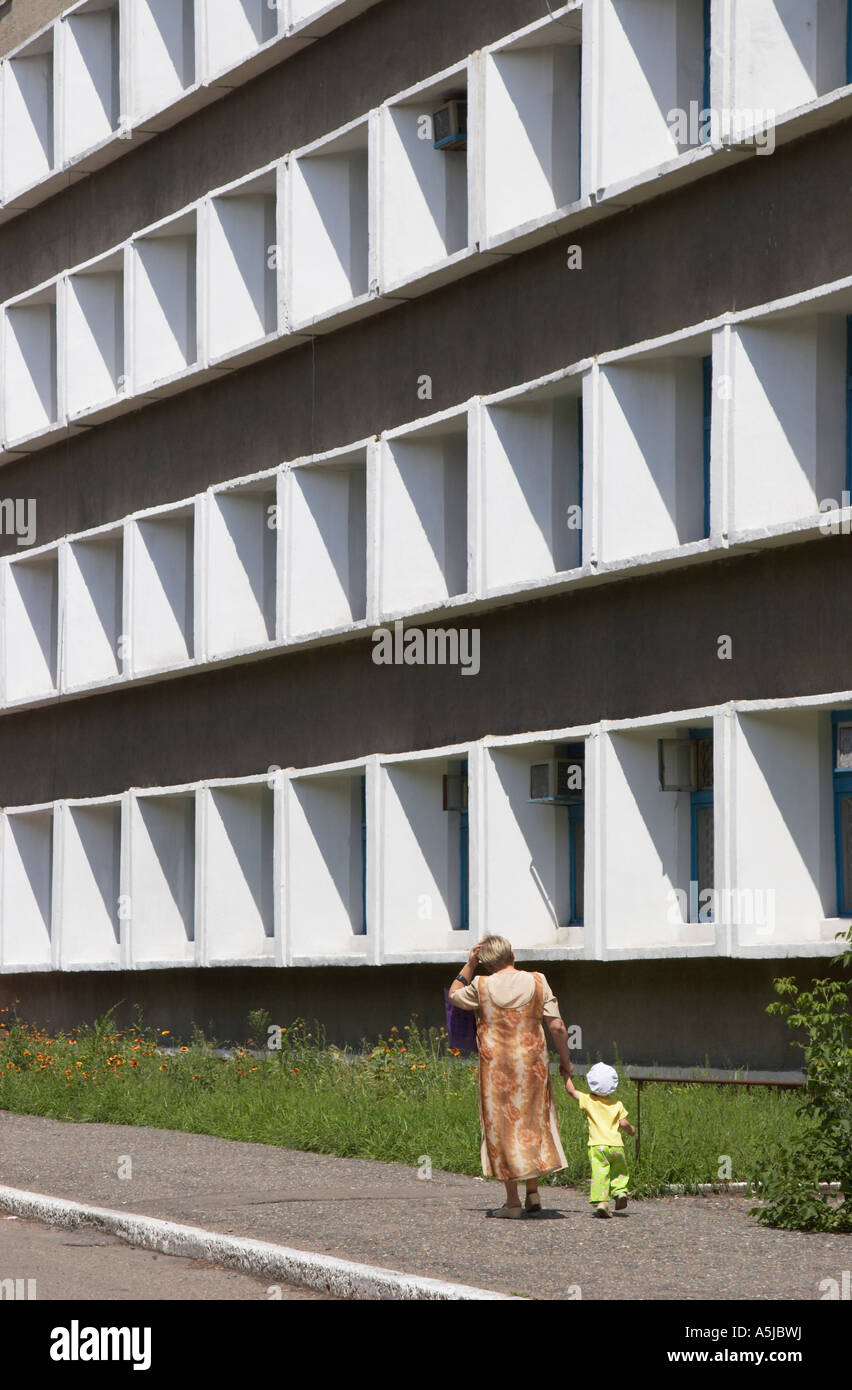 Woman And Child Walking Past Communist Style Building Stock Photo - Alamy