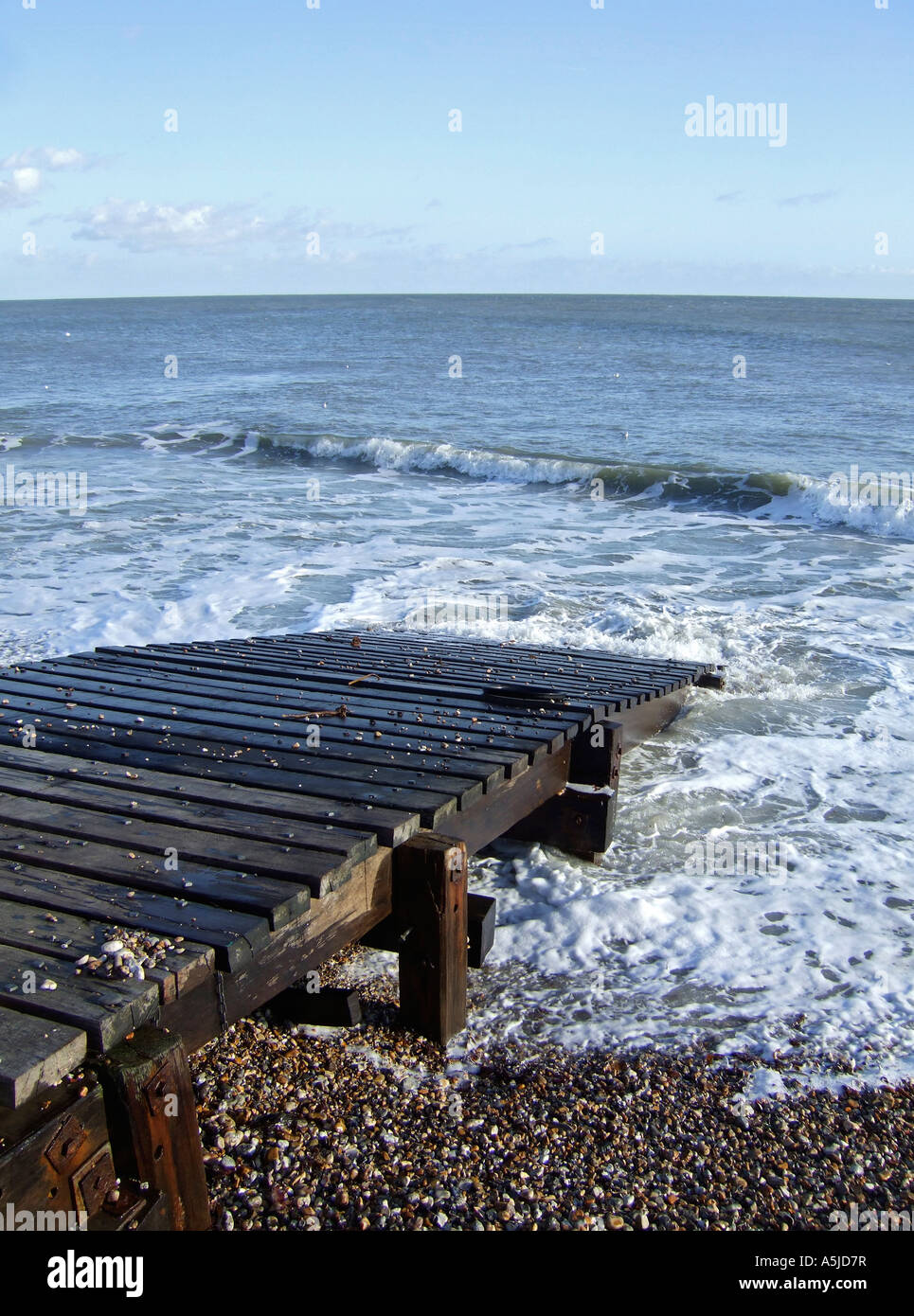 Wooden slip way leading into the sea at Selsey East Beach, West Sussex ...