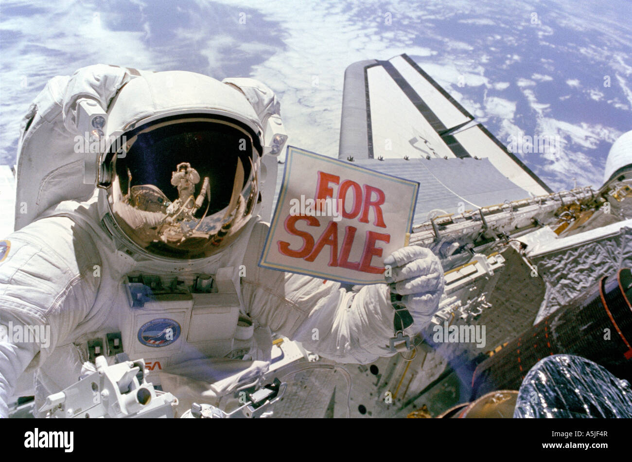 Astronaut Dale A. Gardner holds a "For Sale" sign Stock Photo - Alamy