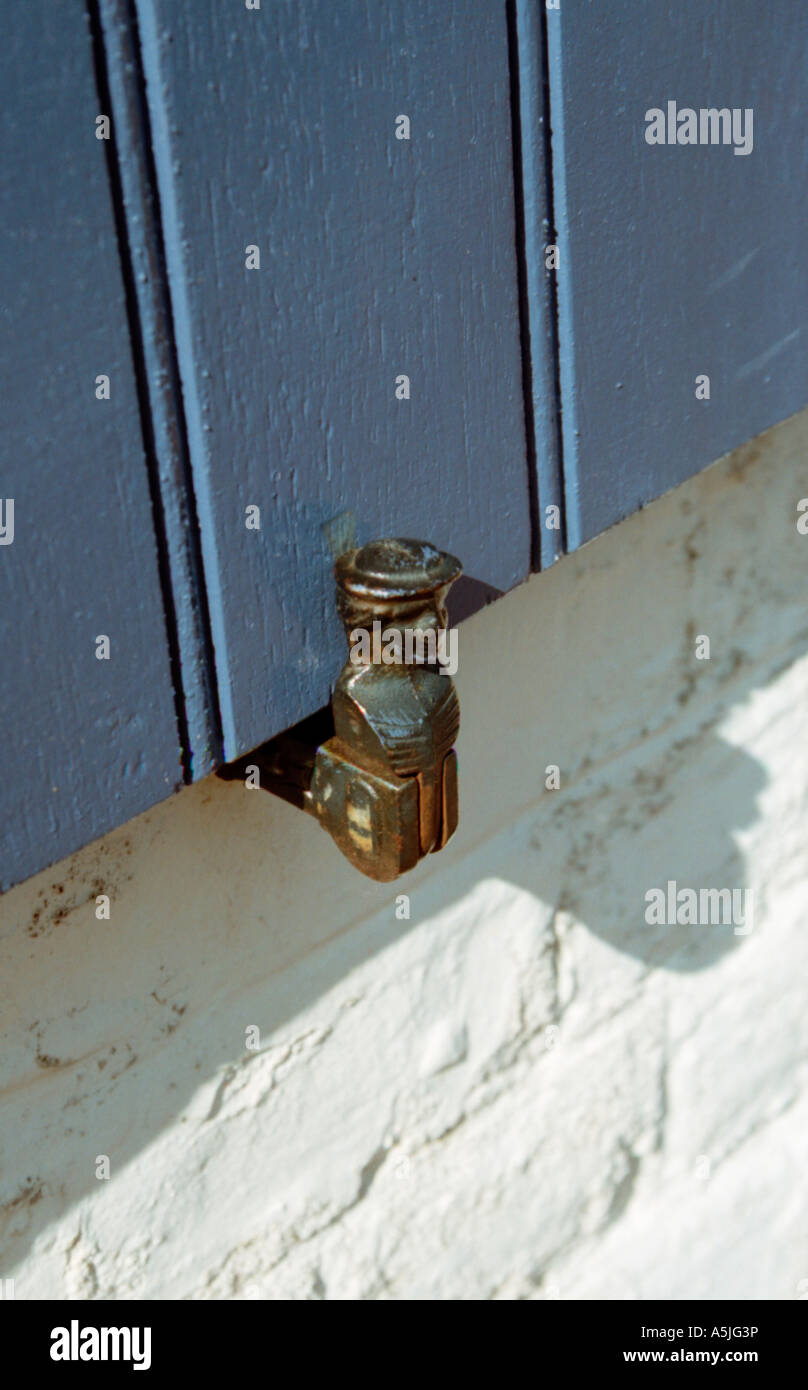 Cast head on window shutter stay St Valery France Stock Photo - Alamy