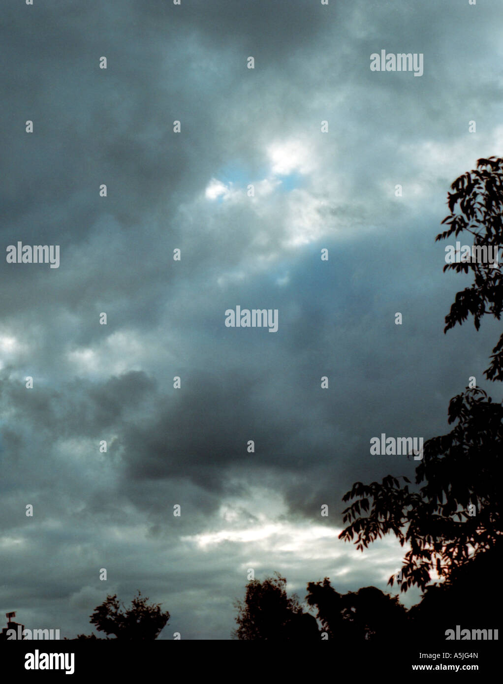 Storm clouds roll in over blue sky Stock Photo - Alamy