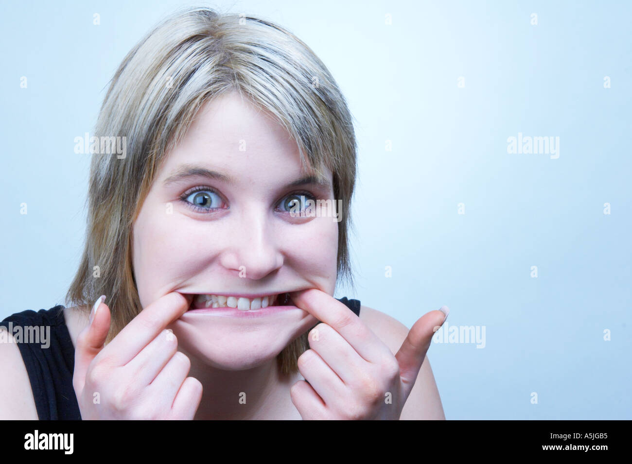 Teenage Girl Silly Face Bleeched Blue Horizontal Stock Photo - Alamy