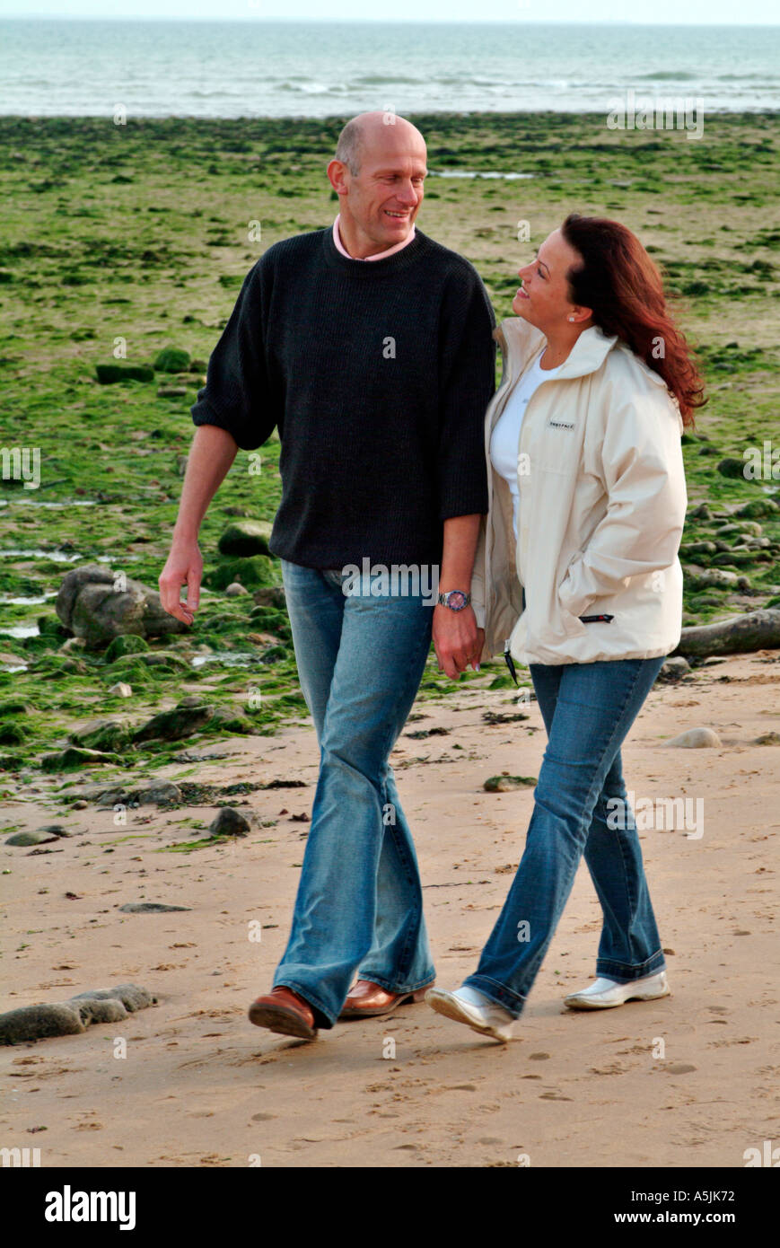 Lovers walking seacoast on hi-res stock photography and images - Alamy