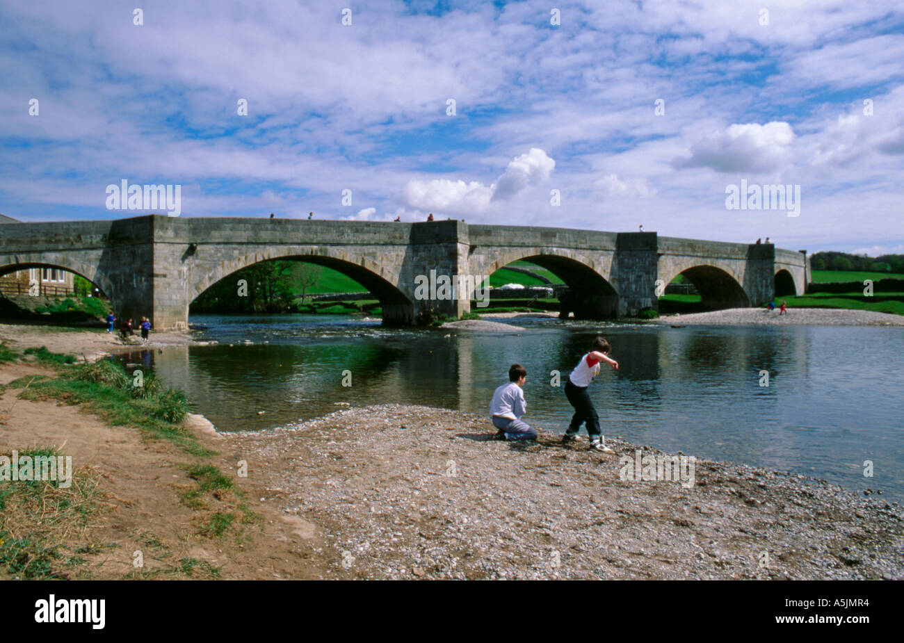 Five arch stone masonry bridge over River Wharfe, village of Burnsall ...