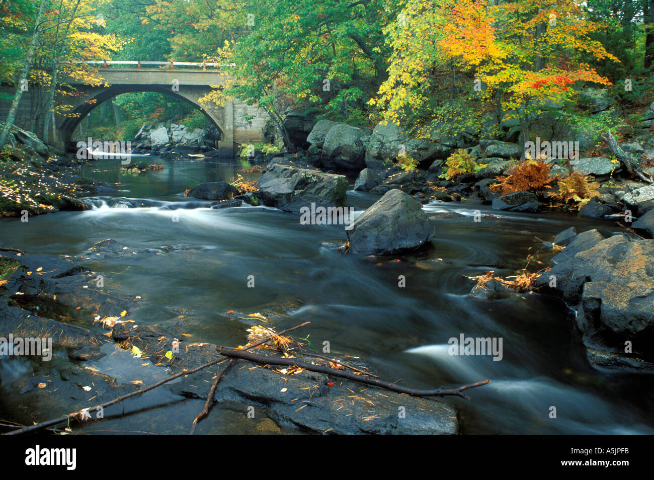 Autumn colors and river rapids with bridge Stock Photo - Alamy