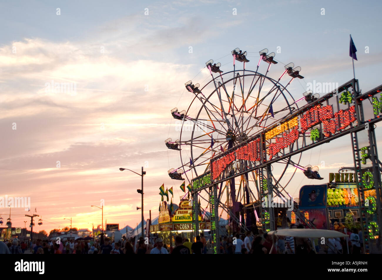 Food stands and ferris wheel at sunset at the Illinois State Fair in ...
