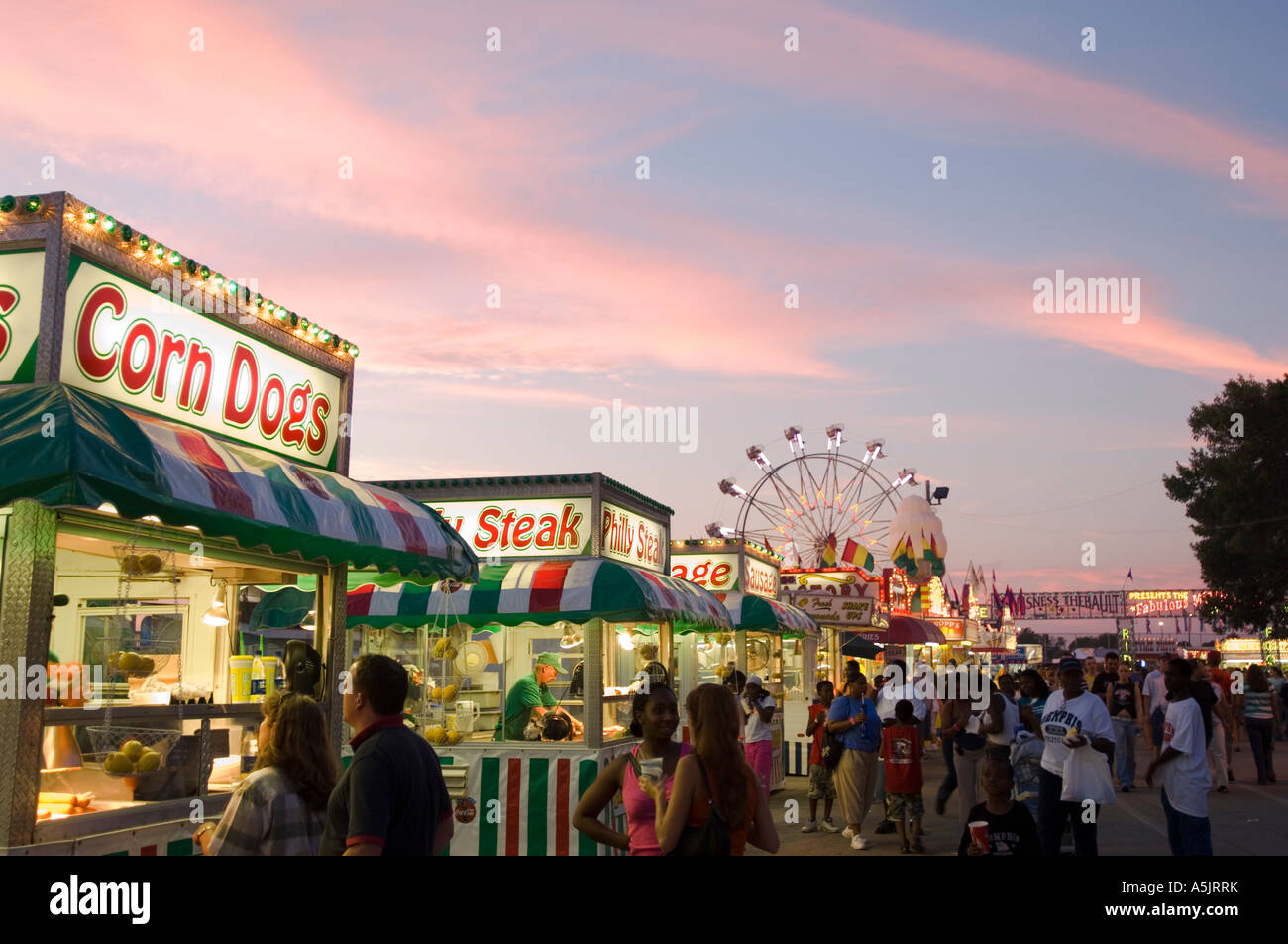 Food stands and ferris wheel at sunset at the Illinois State Fair in ...