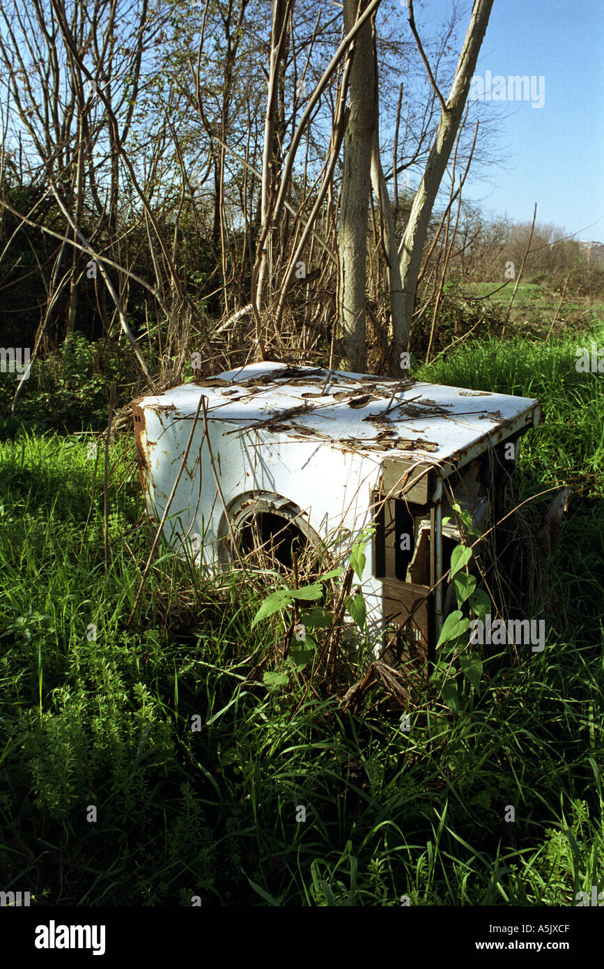 old washing machine dumped in woods Stock Photo - Alamy