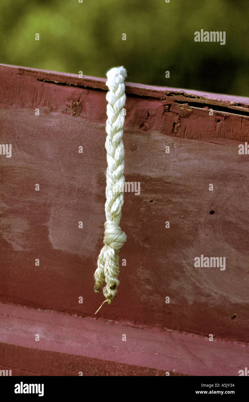 A PIECE OF ROPE HANGING OVER THE SIDE OF A PURPLE BOAT BAPS186 Stock ...