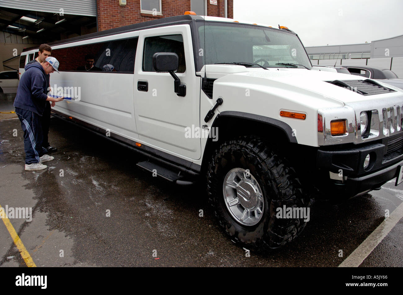 White stretch Hummer being cleaned and checked over by hire company, UK ...