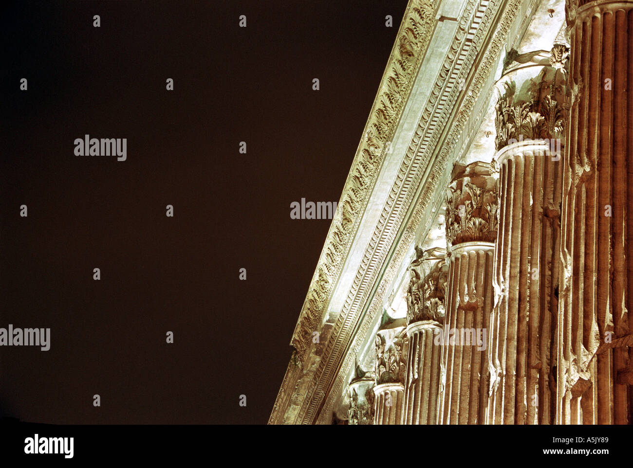 roman temple with columns lit at night rome Stock Photo - Alamy