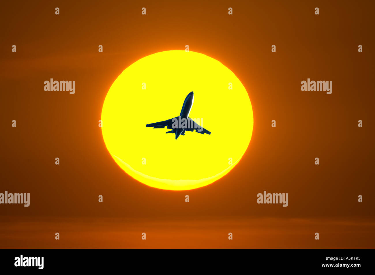 commercial jet takeoff with huge sun in background Stock Photo - Alamy