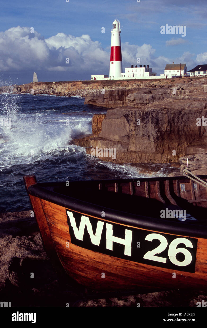 portland bill lighthouse and fishing boat waves on cliff s dorset ...