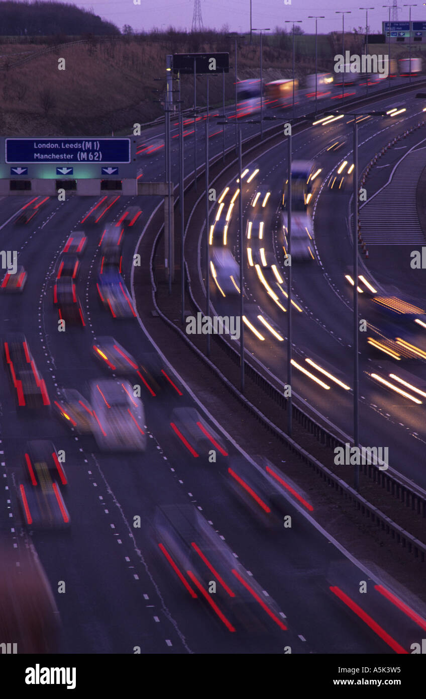 traffic travelling on the A1/M1 motorway at dusk leeds yorkshire uk ...