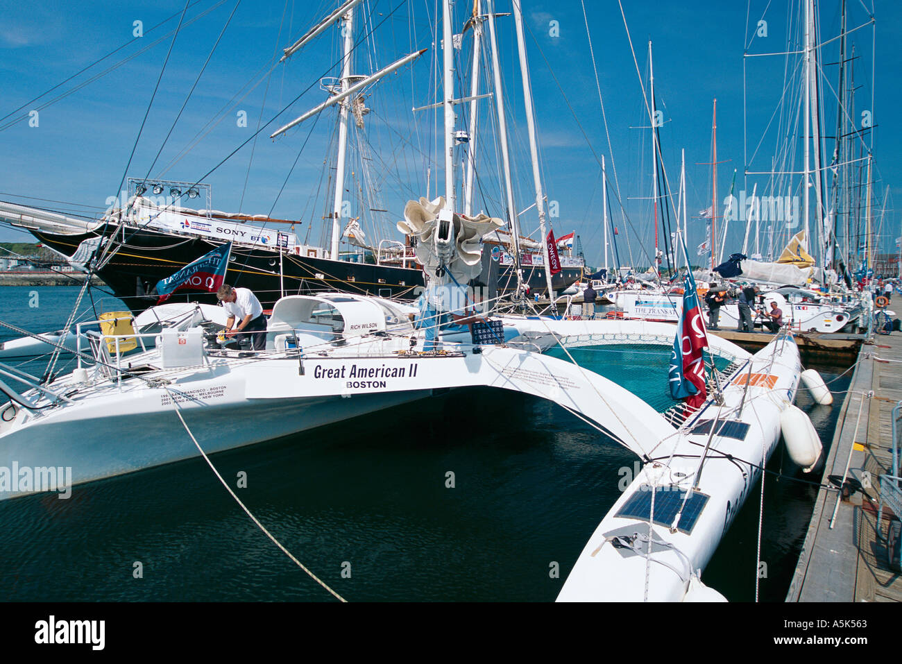 Modern hi tech racing trimaran and an old schooner in port Plymouth ...