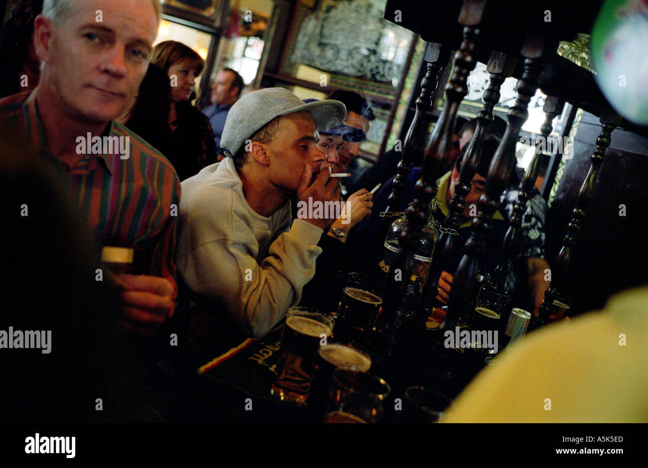 SMOKING AND DRINKING IN TYPICAL EAST END OF LONDON, ENGLAND PUB Stock ...