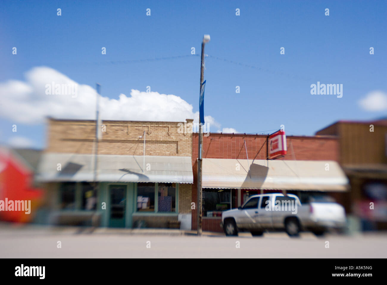 streetside view of storefronts in a small town Stock Photo - Alamy