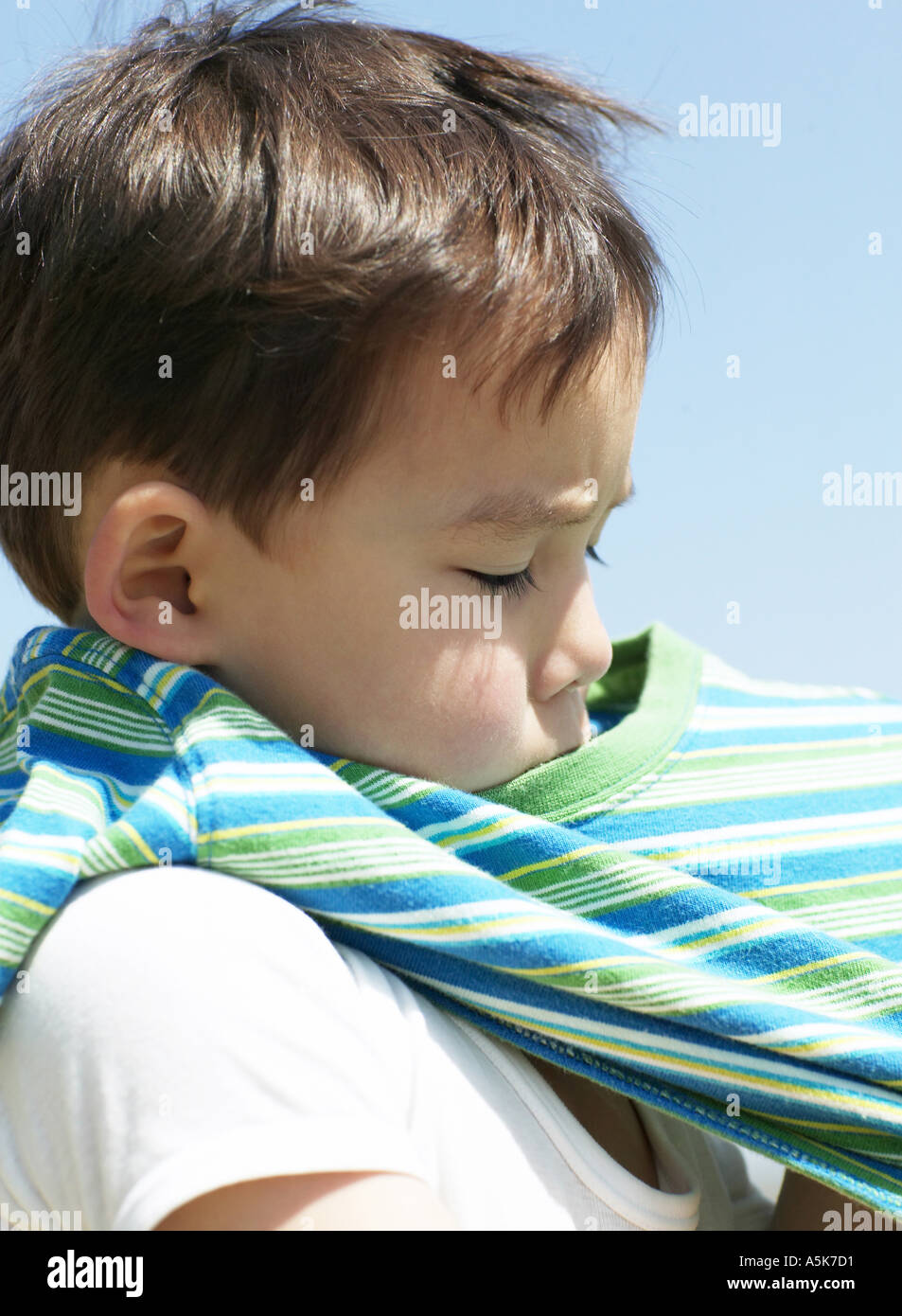Young boy getting dressed Stock Photo - Alamy