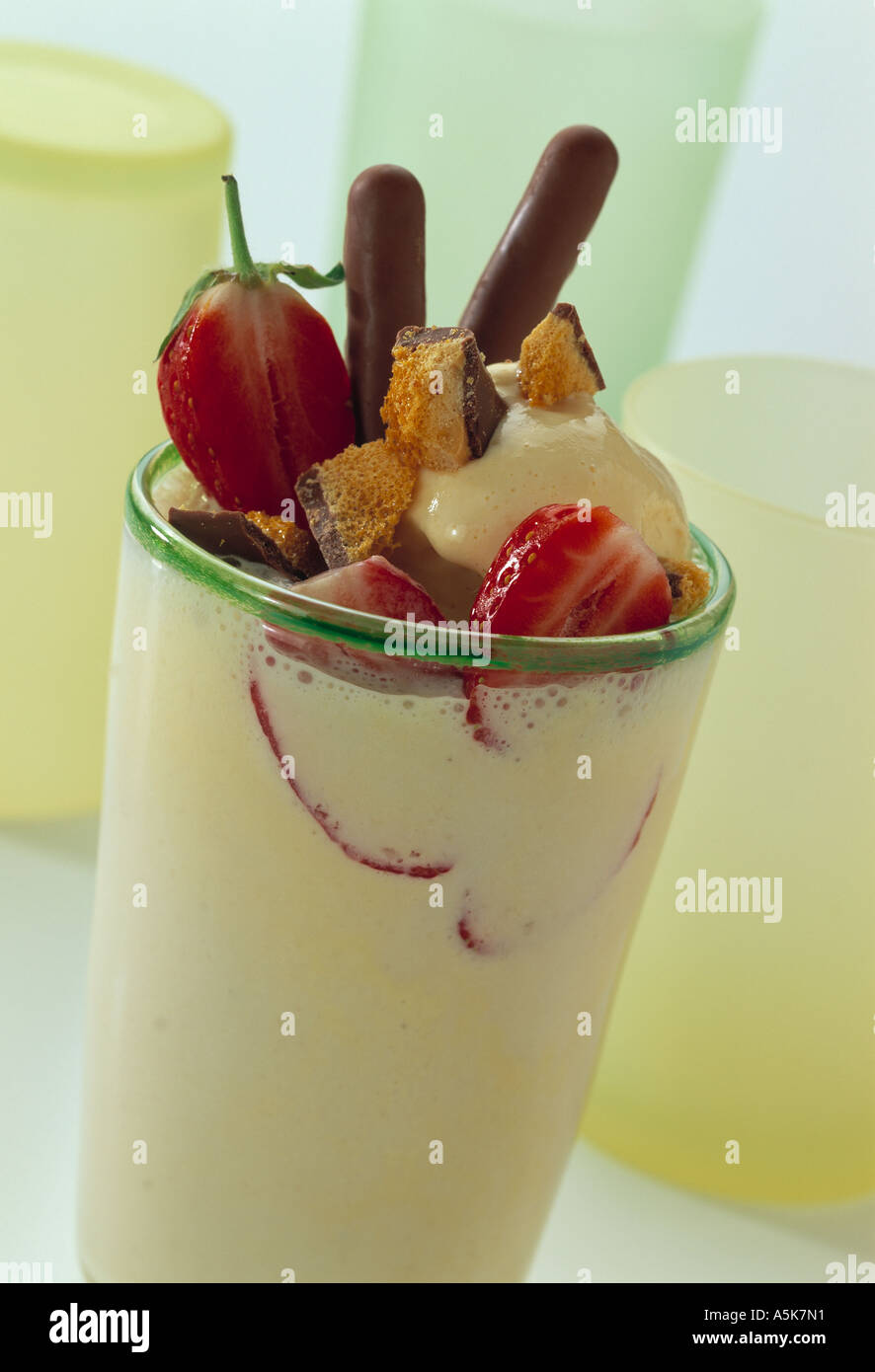 Milk shake with strawberries, chocolate fingers, broken Crunchie pieces ...
