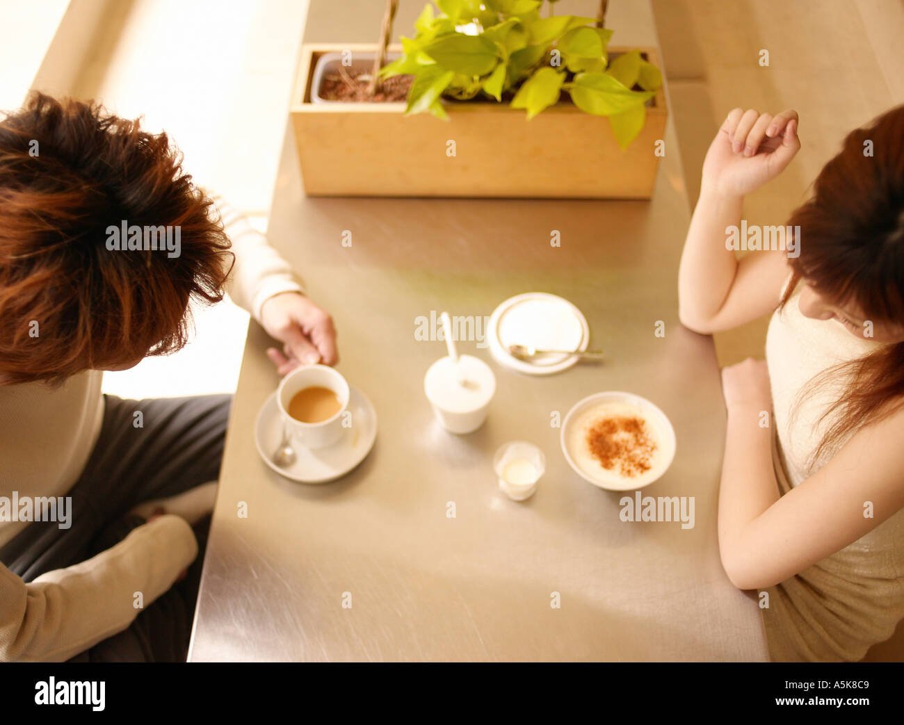 Young couple having tea Stock Photo - Alamy