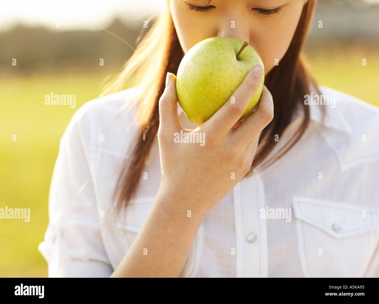 Woman smelling green apple hi-res stock photography and images - Alamy