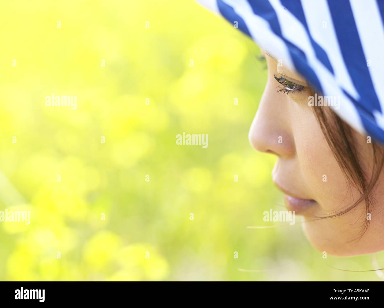 Young woman looking downwards Stock Photo - Alamy