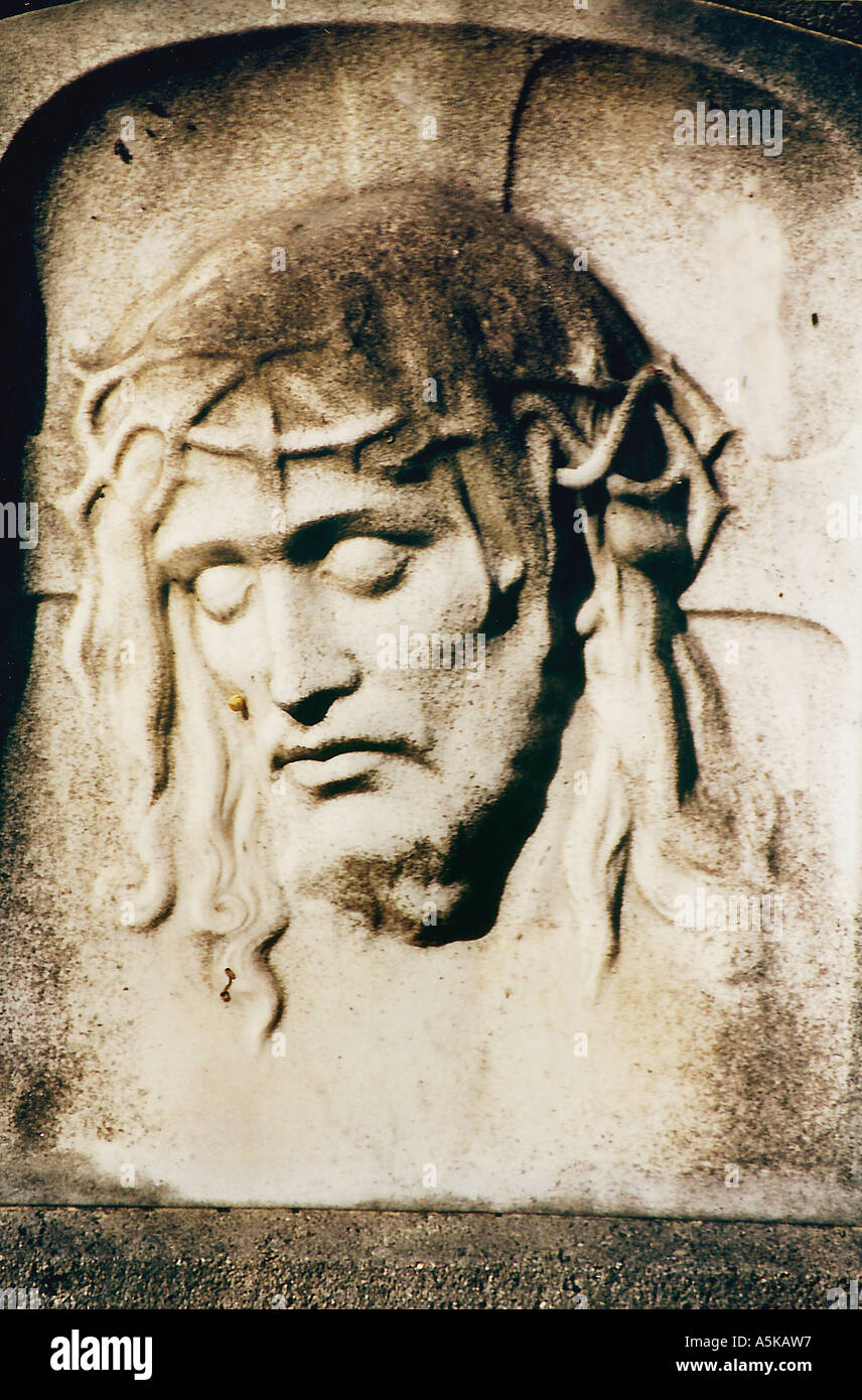 Relief with the head of Jesus Christ on a gravestone at a cemetery ...