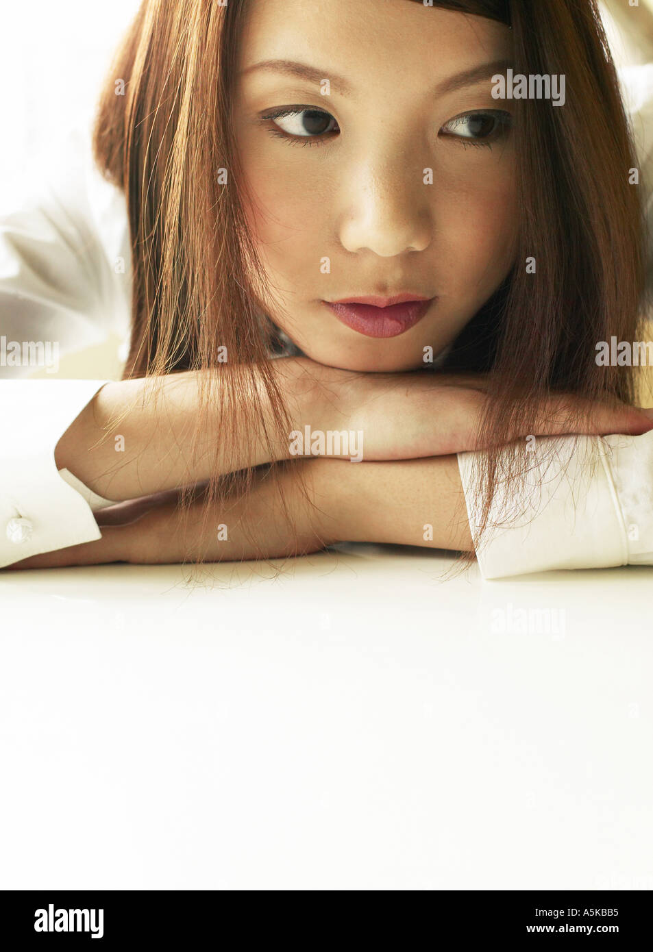 Young women resting her face on her arms Stock Photo - Alamy